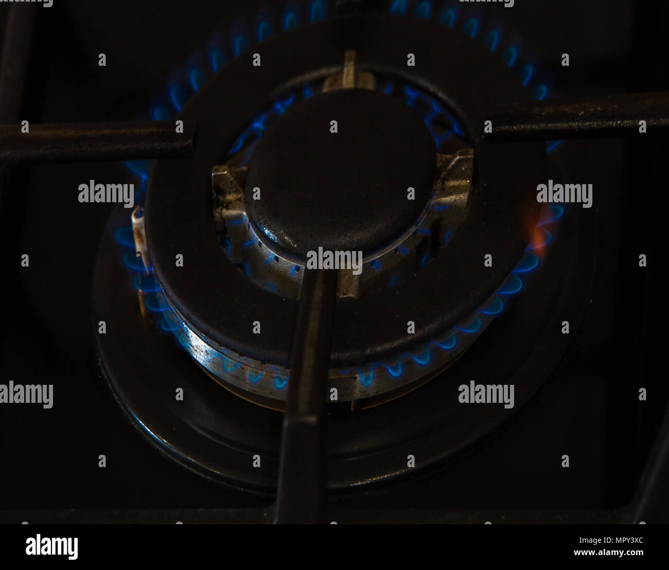 Burning blue gas on the dark stove. Burner gas stove, concept of energy ...