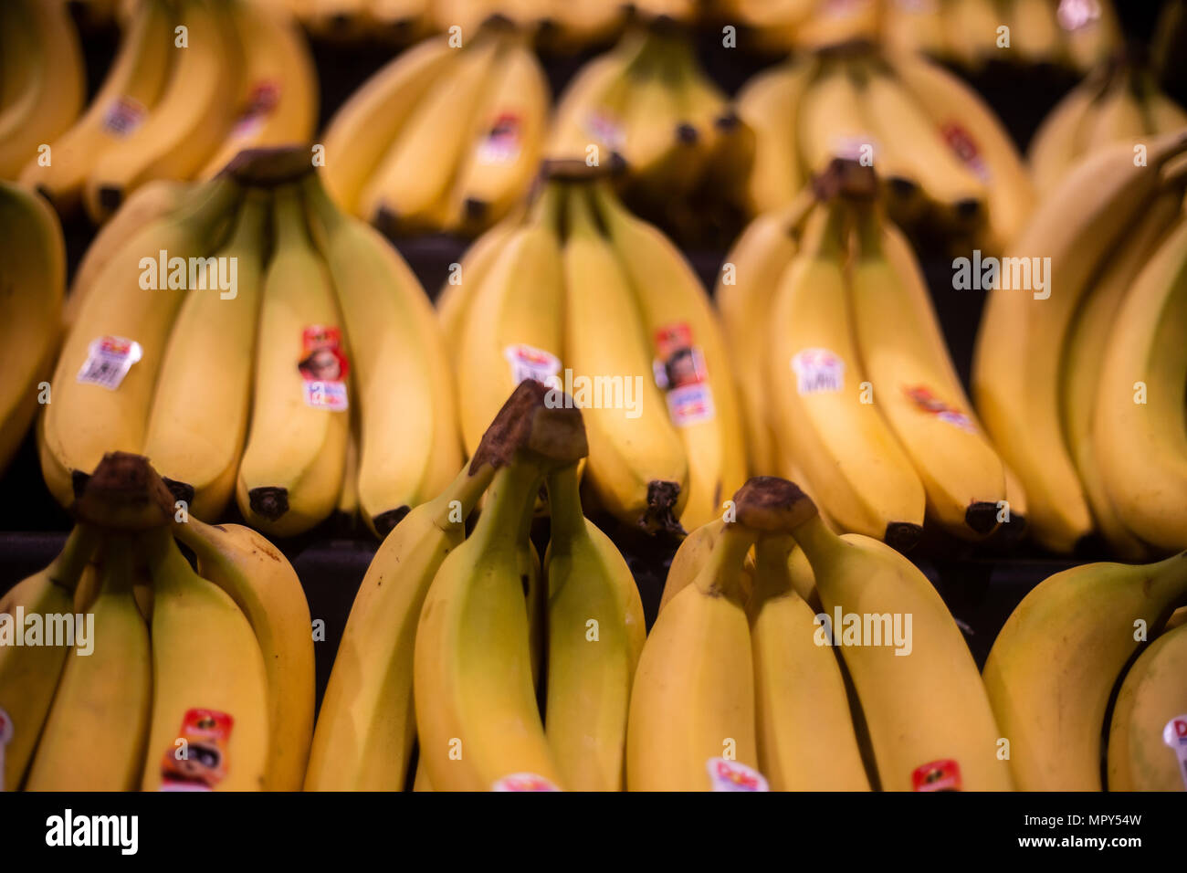 Yellow Unpeeled Bananas on a Grocery Display Close Up Stock Photo - Alamy