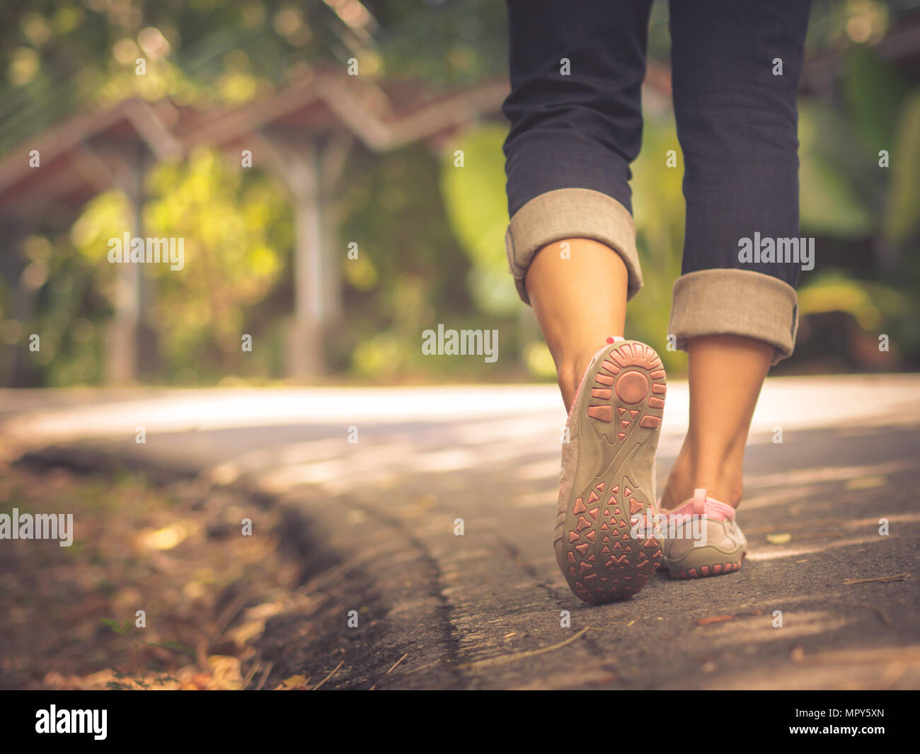 Closeup woman walking towards on the road side. Step concept Stock ...