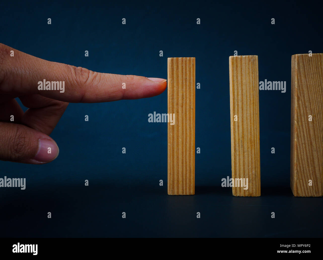 Finger pushing dominoes hi-res stock photography and images - Alamy