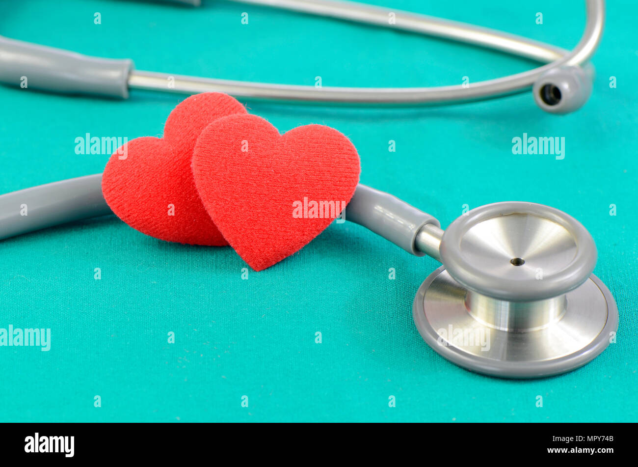 Stethoscope and hearts on green background in heart check up concept ...