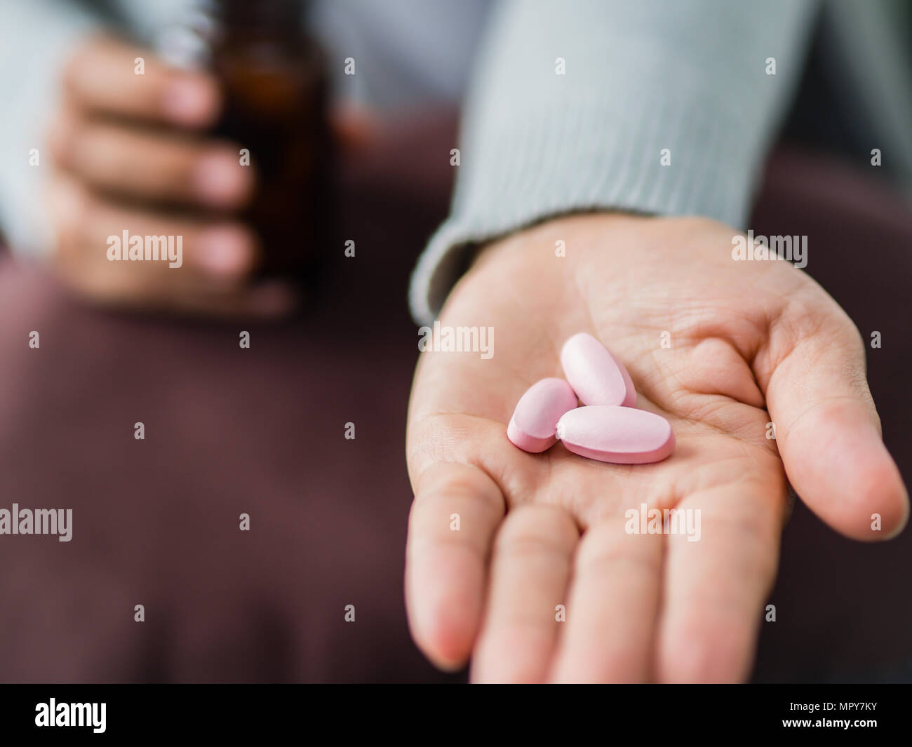 Closeup woman hand holding a pill. Healthcare, medical supplements ...