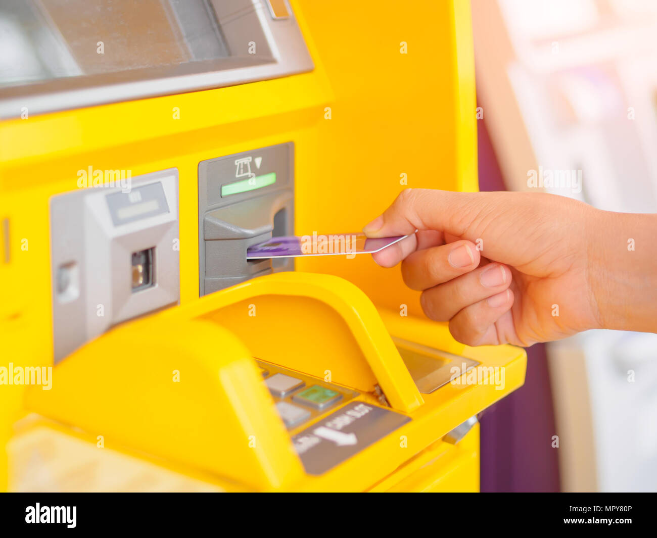 Close-up of woman's hand inserting debit card into an ATM machine Stock ...