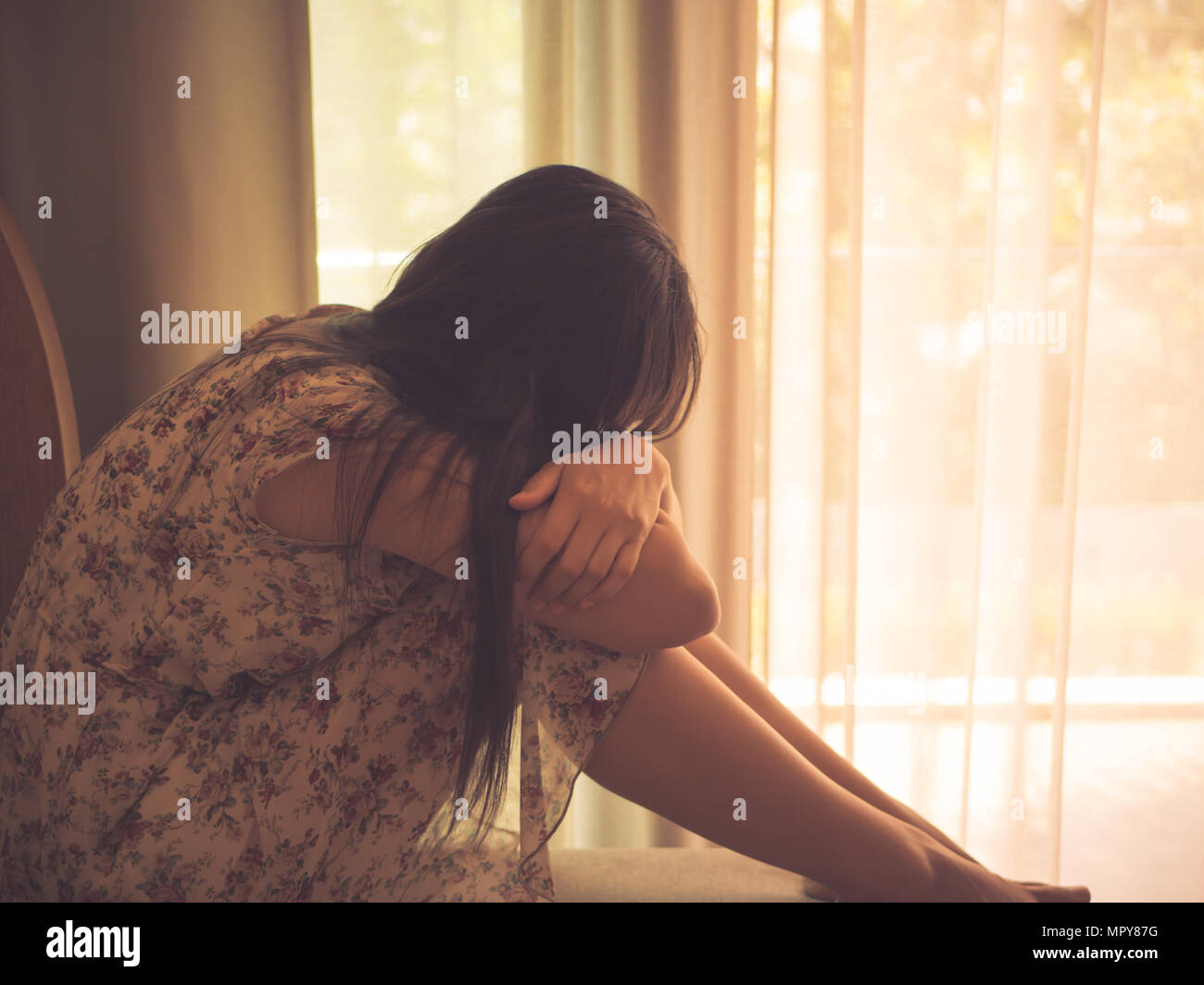 Depressed Woman Hug Her Knee And Cry While Sitting Alone On The Floor