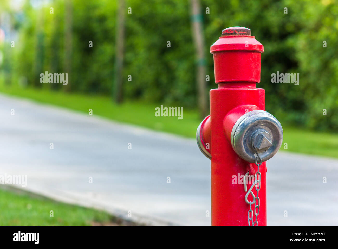 Red fire hydrant along the road close up Stock Photo - Alamy