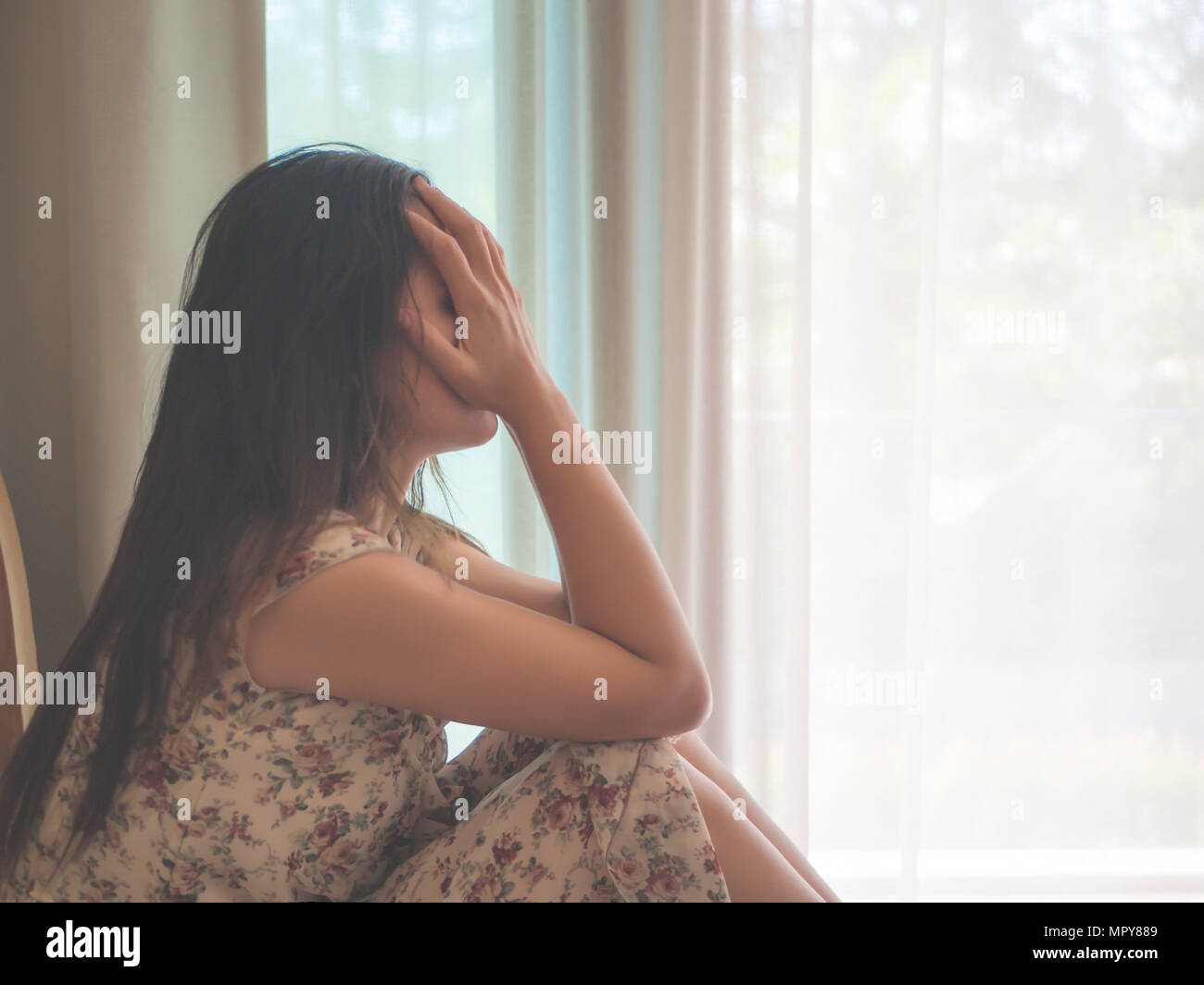 Closeup depressed woman crying while sitting alone on the floor. Sad ...