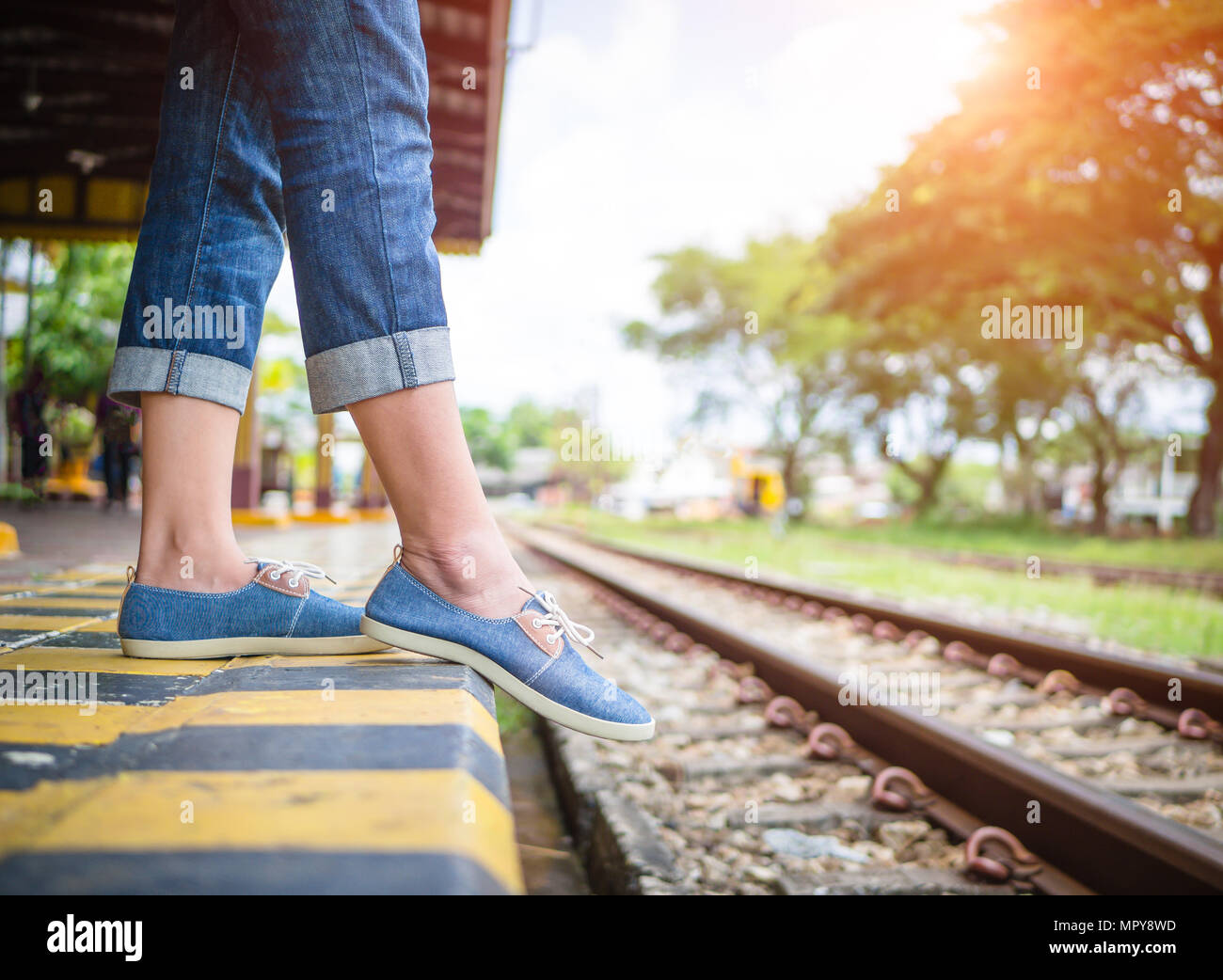 Closeup young girl tourism danger walking step is falling to railway at ...