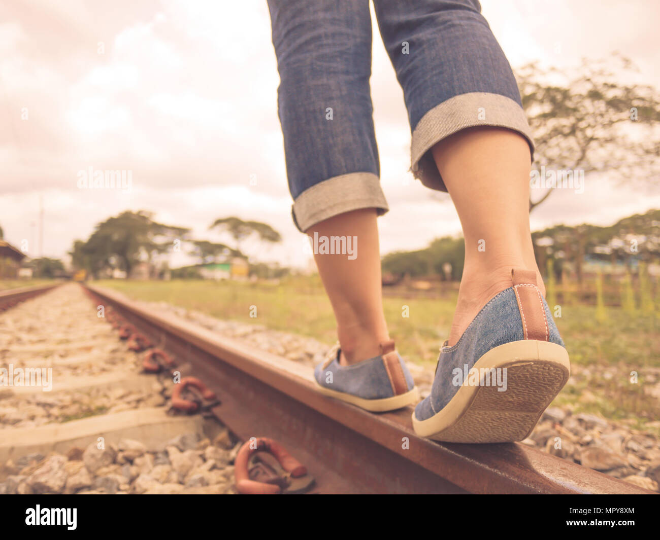 Retro style of woman walking on the railway. Travel and step concept ...