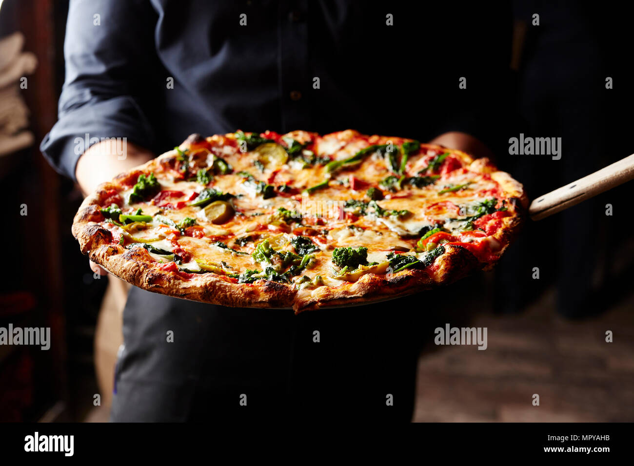 Man holding pizza hi-res stock photography and images - Alamy