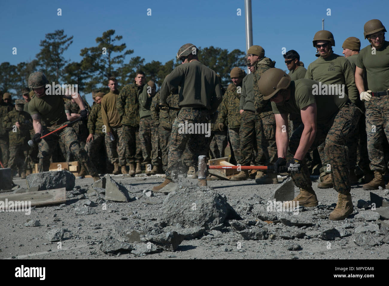 Marines race to break blocks of cement in a competition to see who can ...