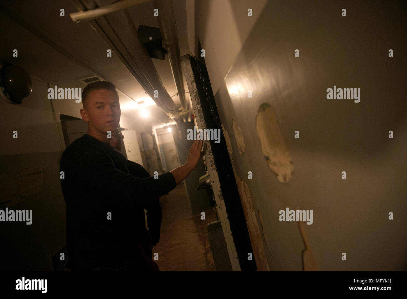 A U.S. Marine with Black Sea Rotational Force 17.1 checks out a cell block during a tour of the ...
