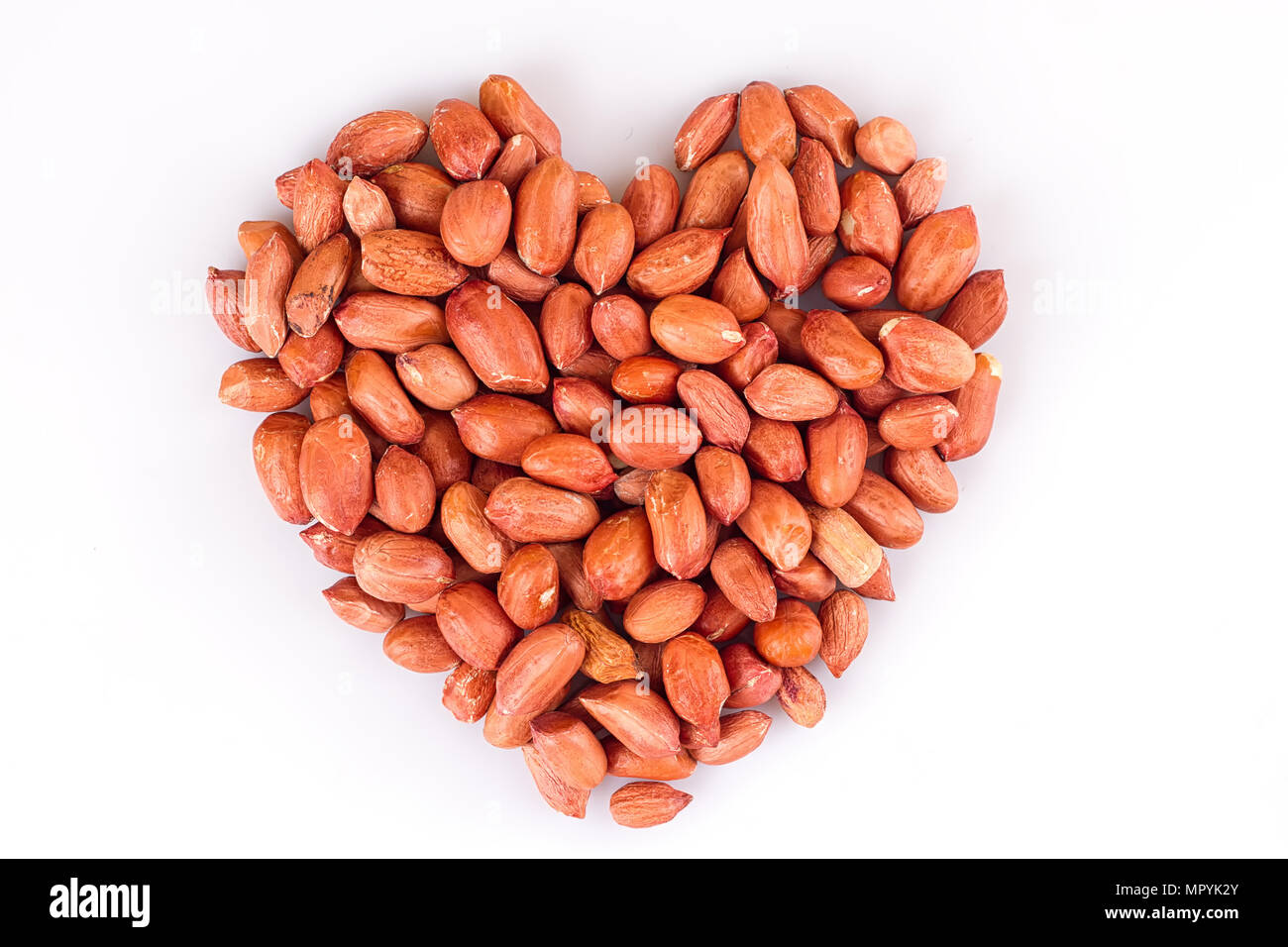 Peanuts in heart symbol isolated on white Stock Photo - Alamy