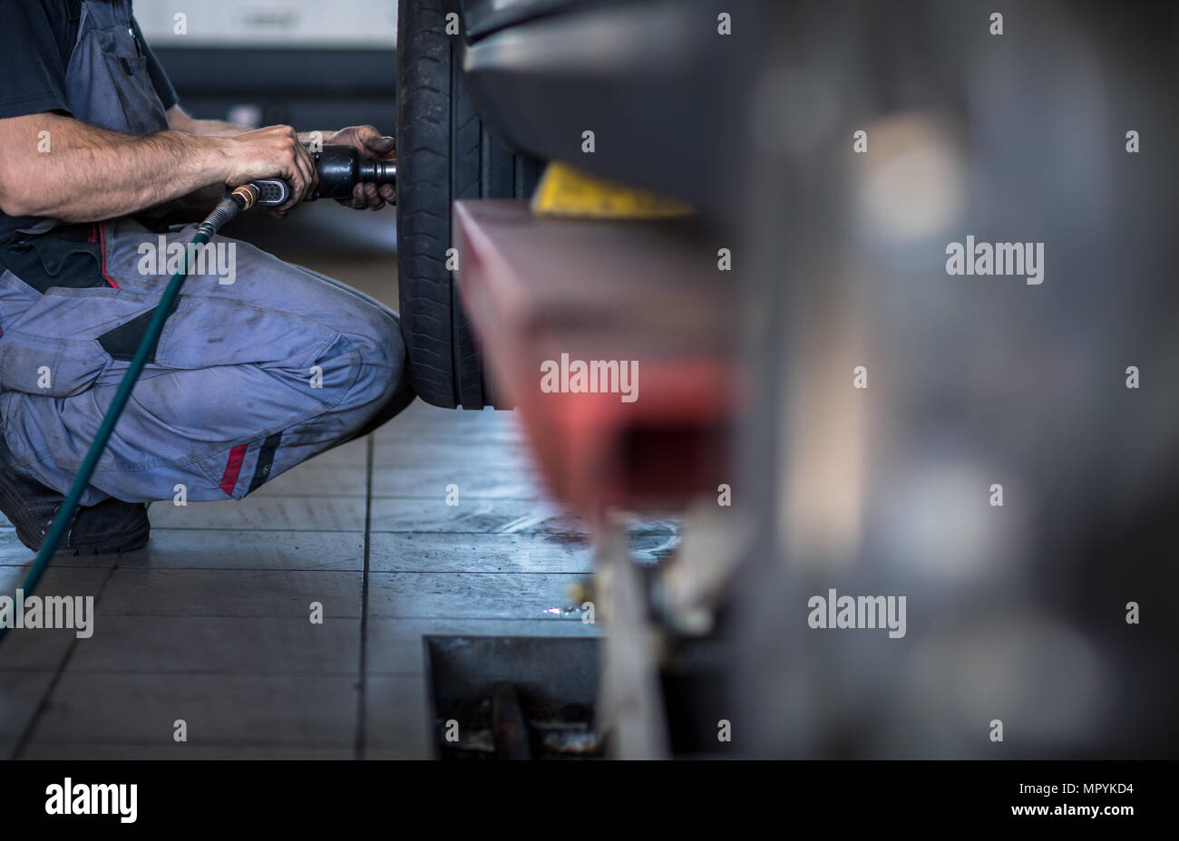 Wheel change - balancing/repairing wheels on a modern car in a garage ...