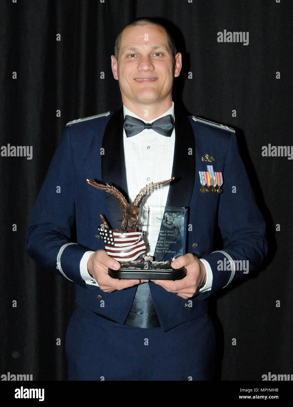 U.S. Air Force Capt. Ross Rollinger receives the Lt. Col. John J ...