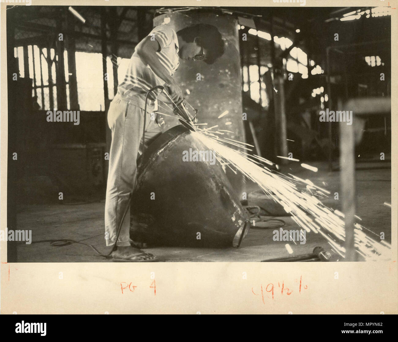 Philippines - Industry - Man sanding metal Stock Photo - Alamy