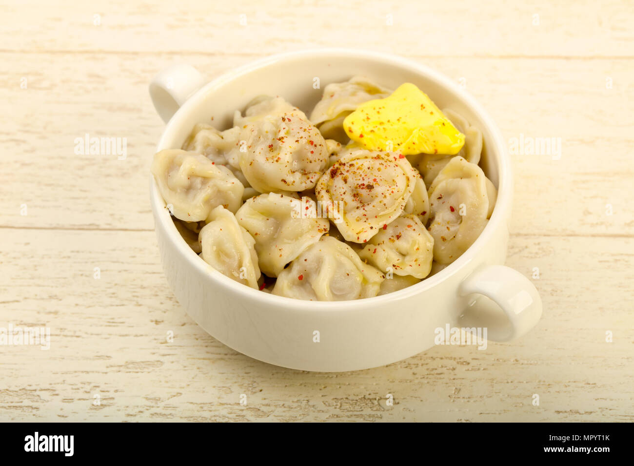 Russian dumplings with butter, pepper and spices Stock Photo - Alamy