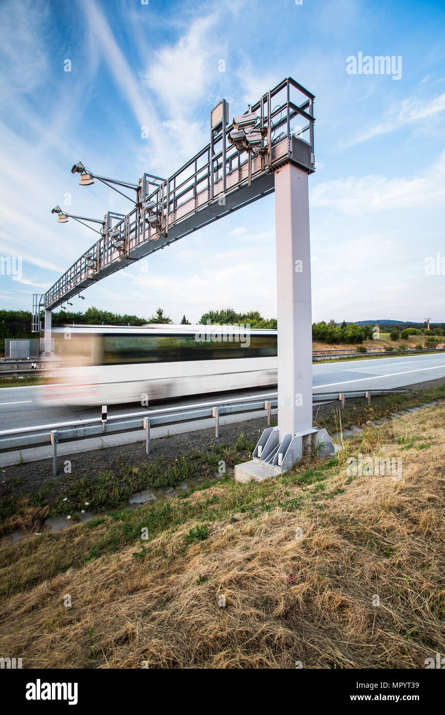 truck passing through a toll gate on a highway (motion blurred image ...