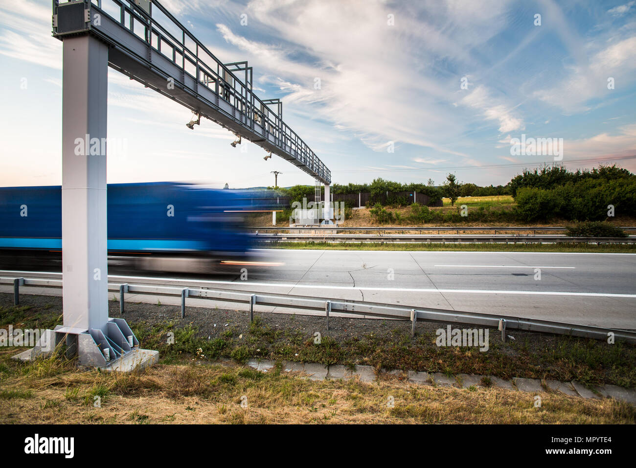 truck passing through a toll gate on a highway (motion blurred image ...