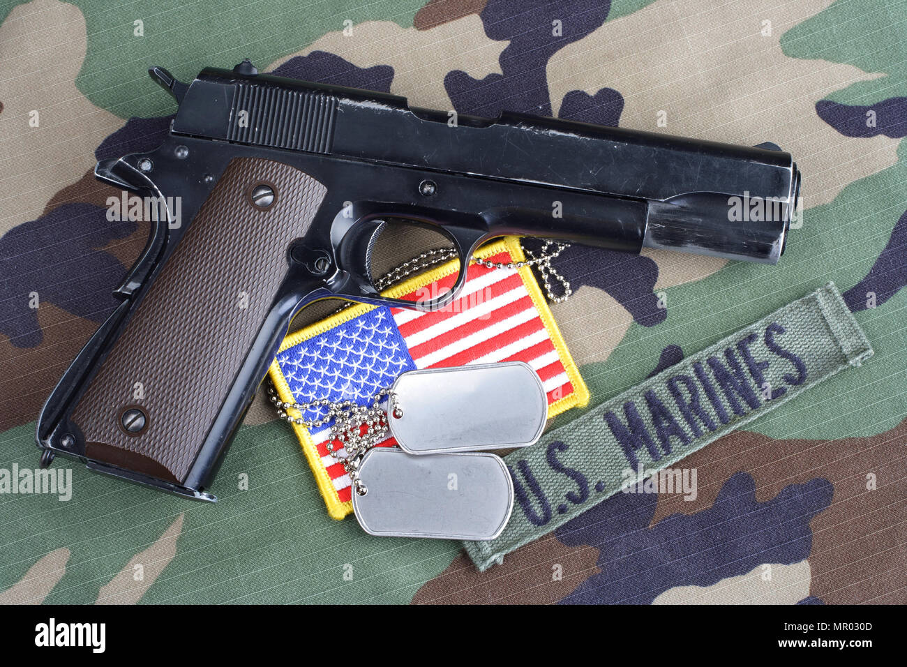 KIEV, UKRAINE - June 6, 2015. US MARINES branch tape, M1911 handgun ...