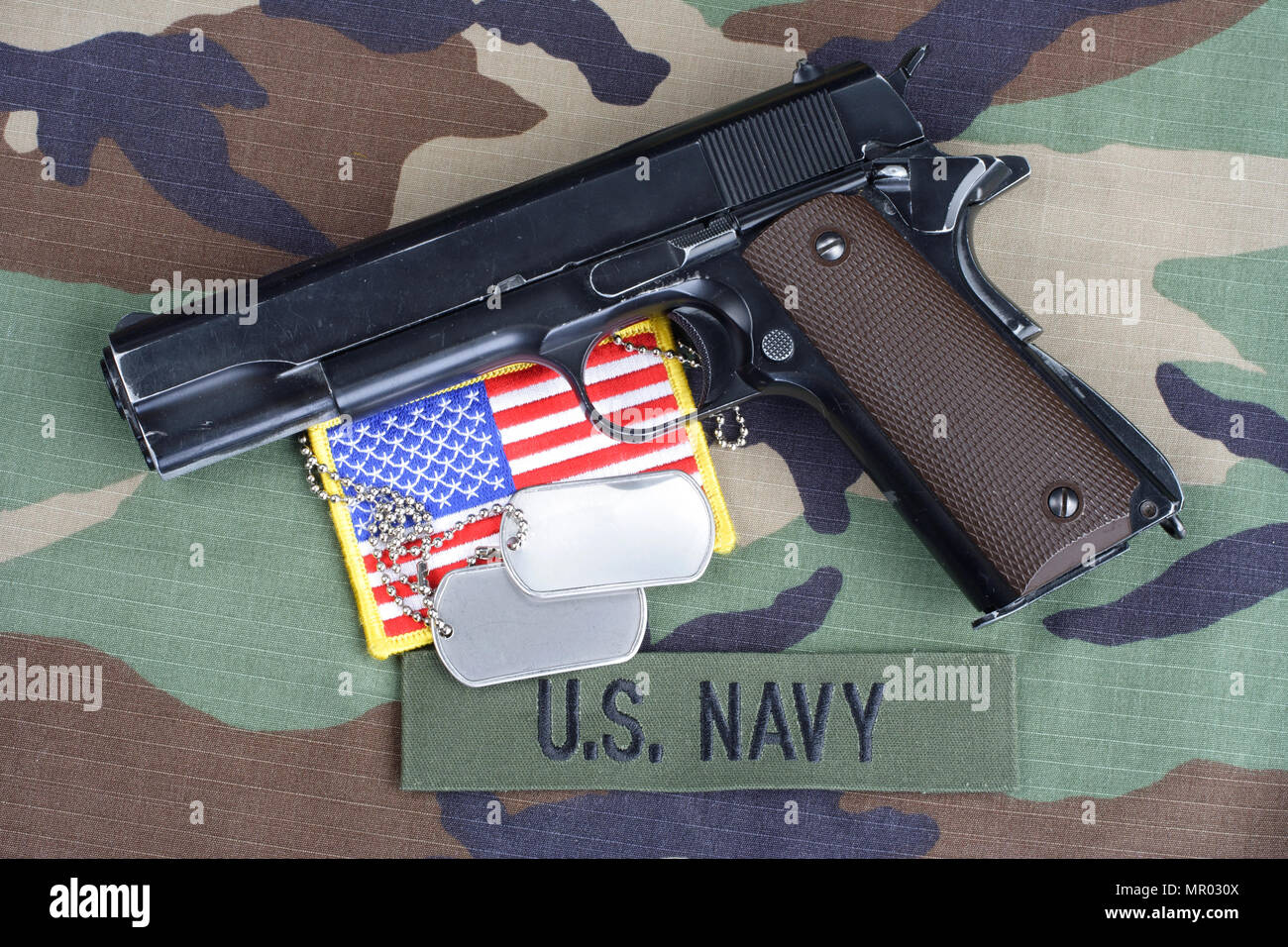 KIEV, UKRAINE - June 6, 2015. US NAVY branch tape, M1911 handgun with ...