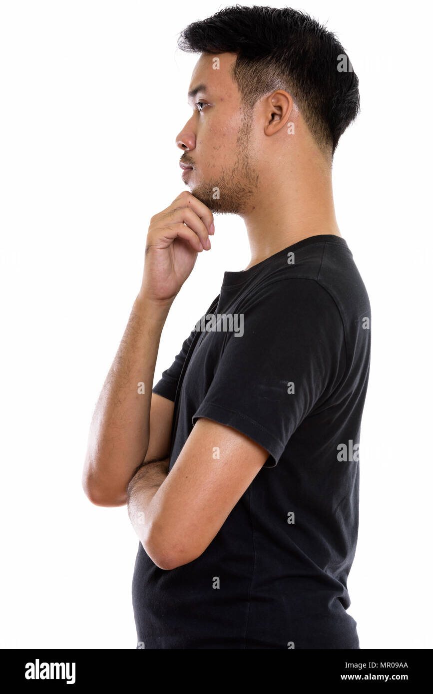 Profile view of young Asian man thinking Stock Photo - Alamy