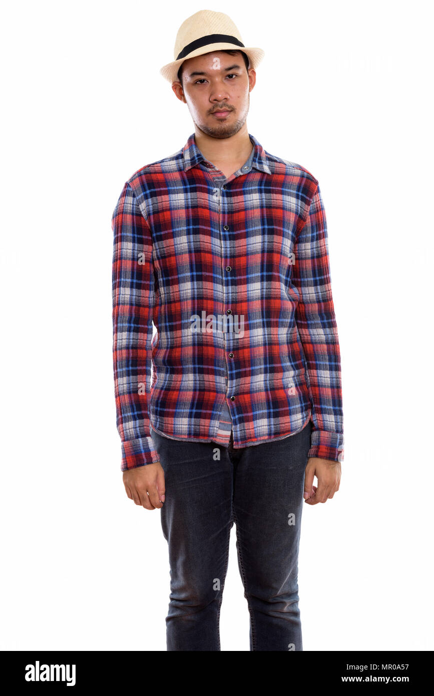 Studio shot of young Asian man standing Stock Photo - Alamy