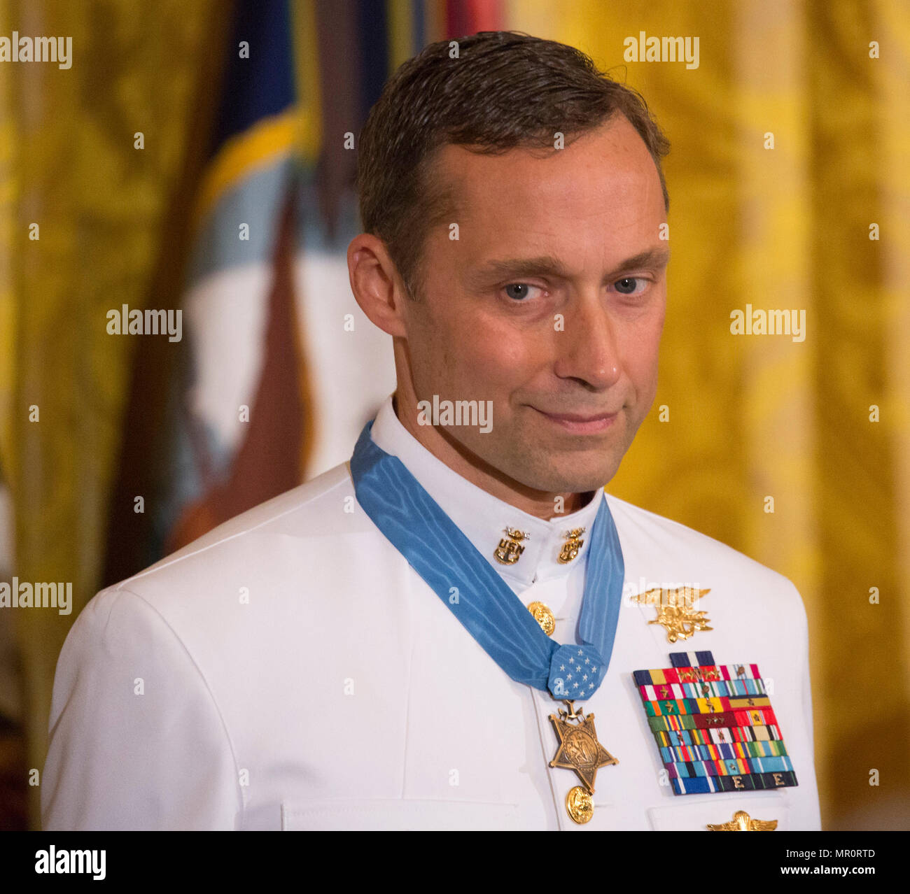 Retired Master Chief Petty Officer Britt K. Slabinski listens after ...