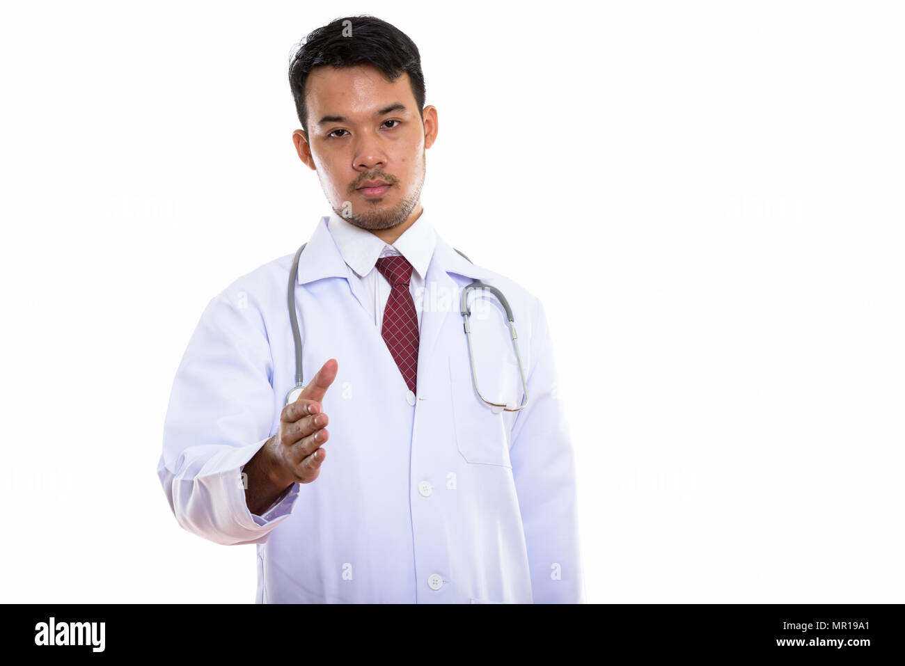 Studio shot of young Asian man doctor giving handshake Stock Photo - Alamy