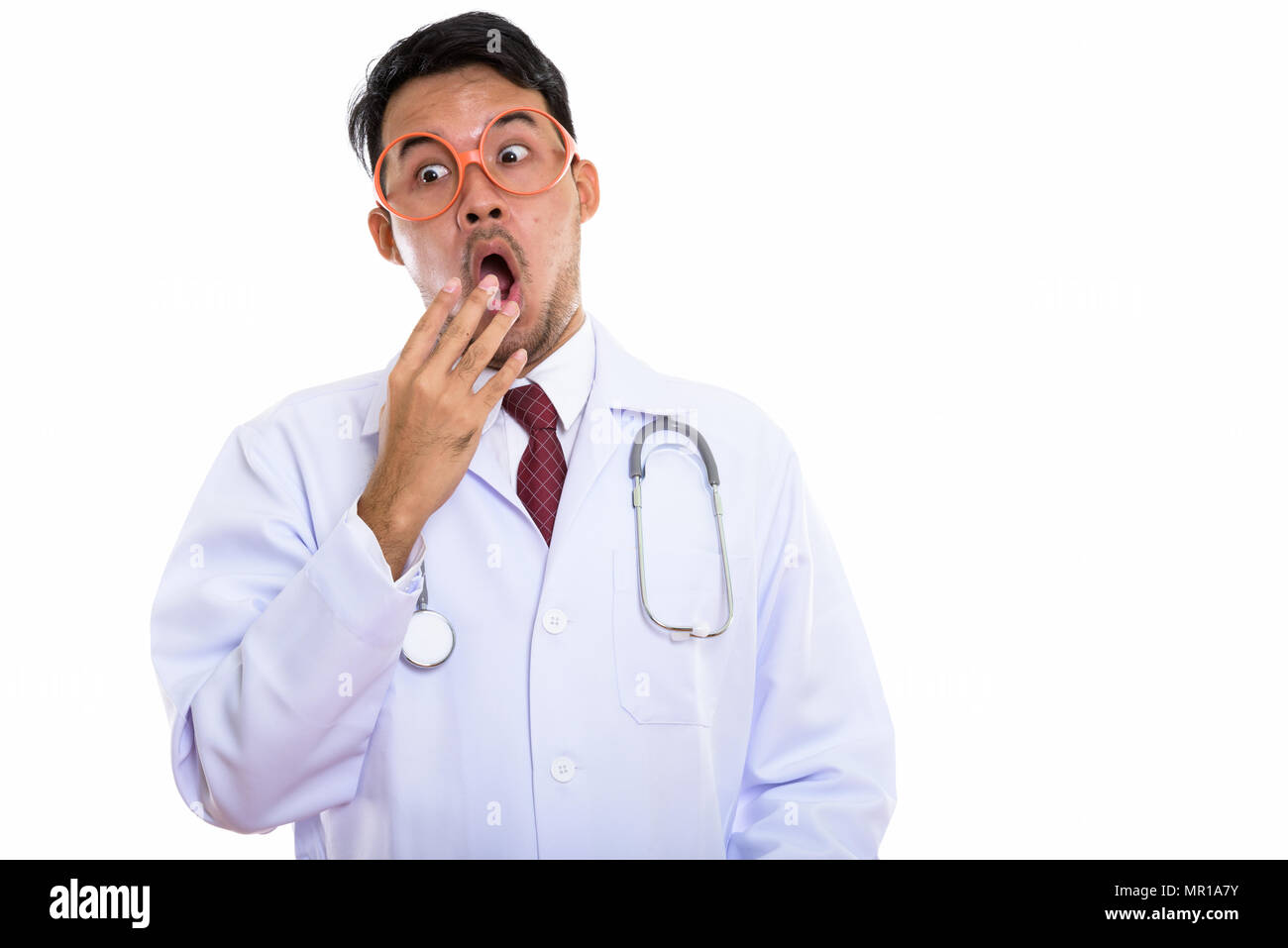 Studio shot of young Asian man doctor wearing eyeglasses looking Stock ...