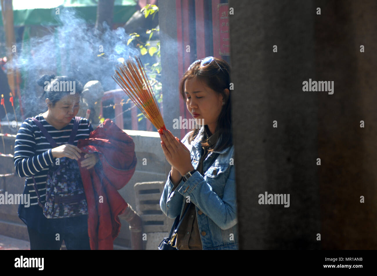 Believers pray and light incense in the temple A-Ma in Macao, China ...