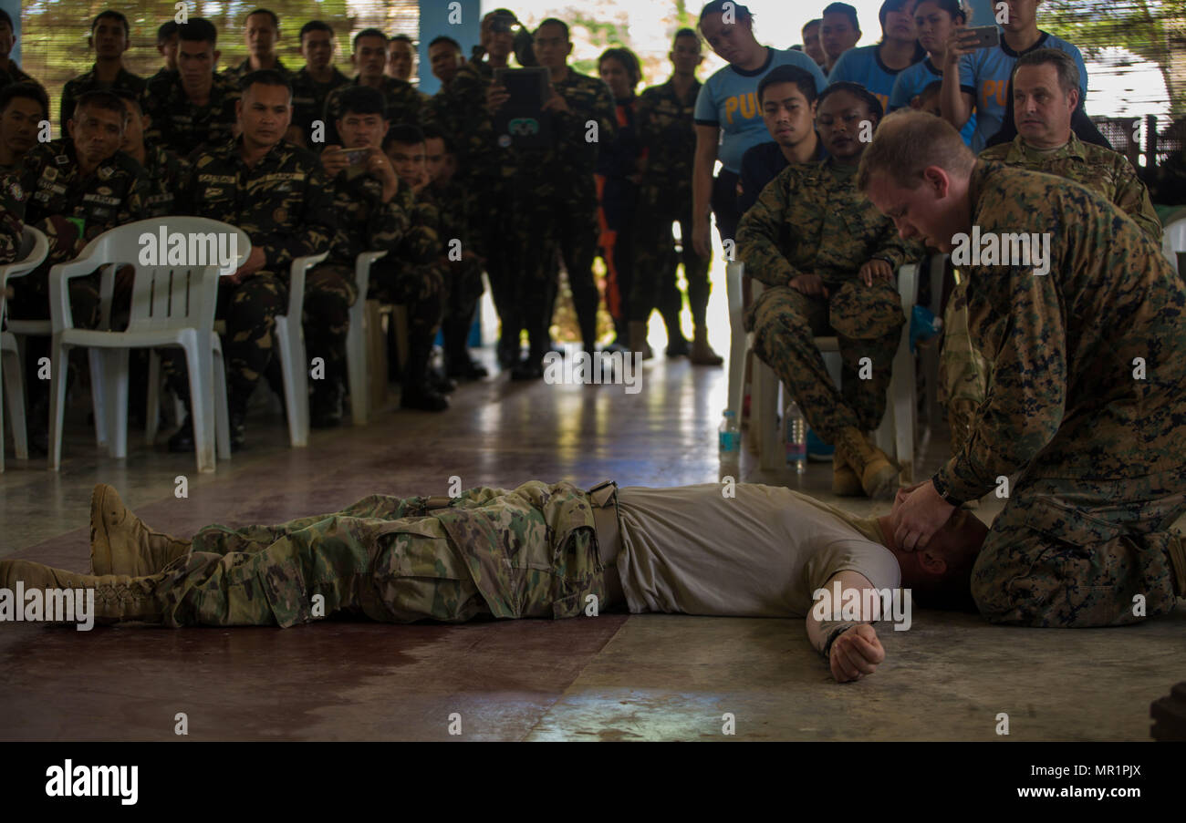 U.S. Navy Petty Officer 3rd Class Jason McDonough demonstrates how to ...