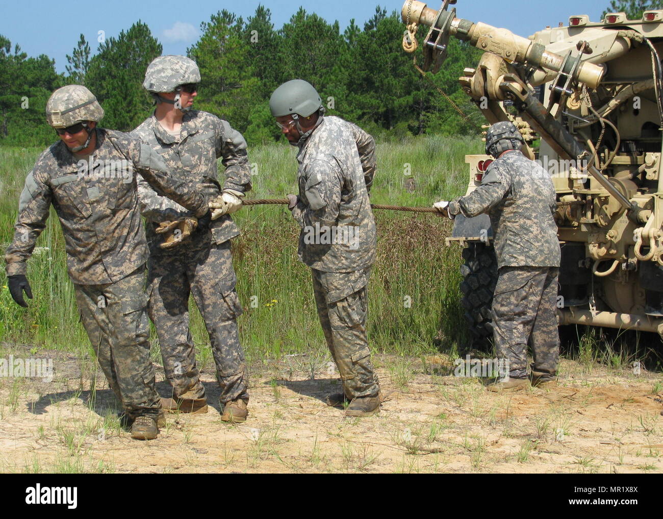 National Guard Soldiers demonstrate proper use of personal protective ...