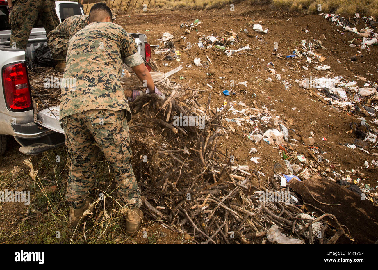 Marines with Headquarters Battalion dump debris at the landfill aboard ...