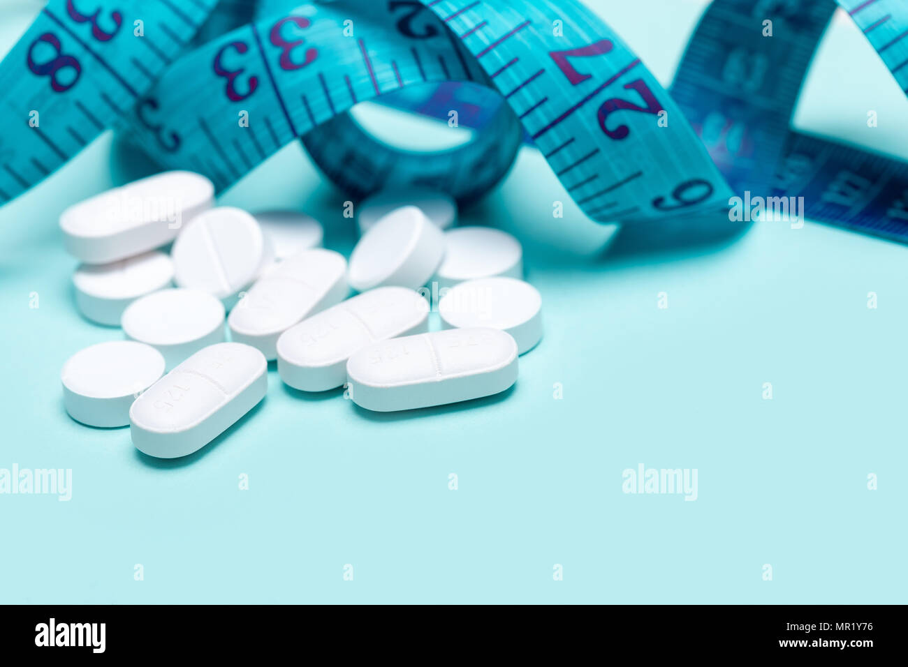 Pills spilling out of pill bottle Stock Photo - Alamy