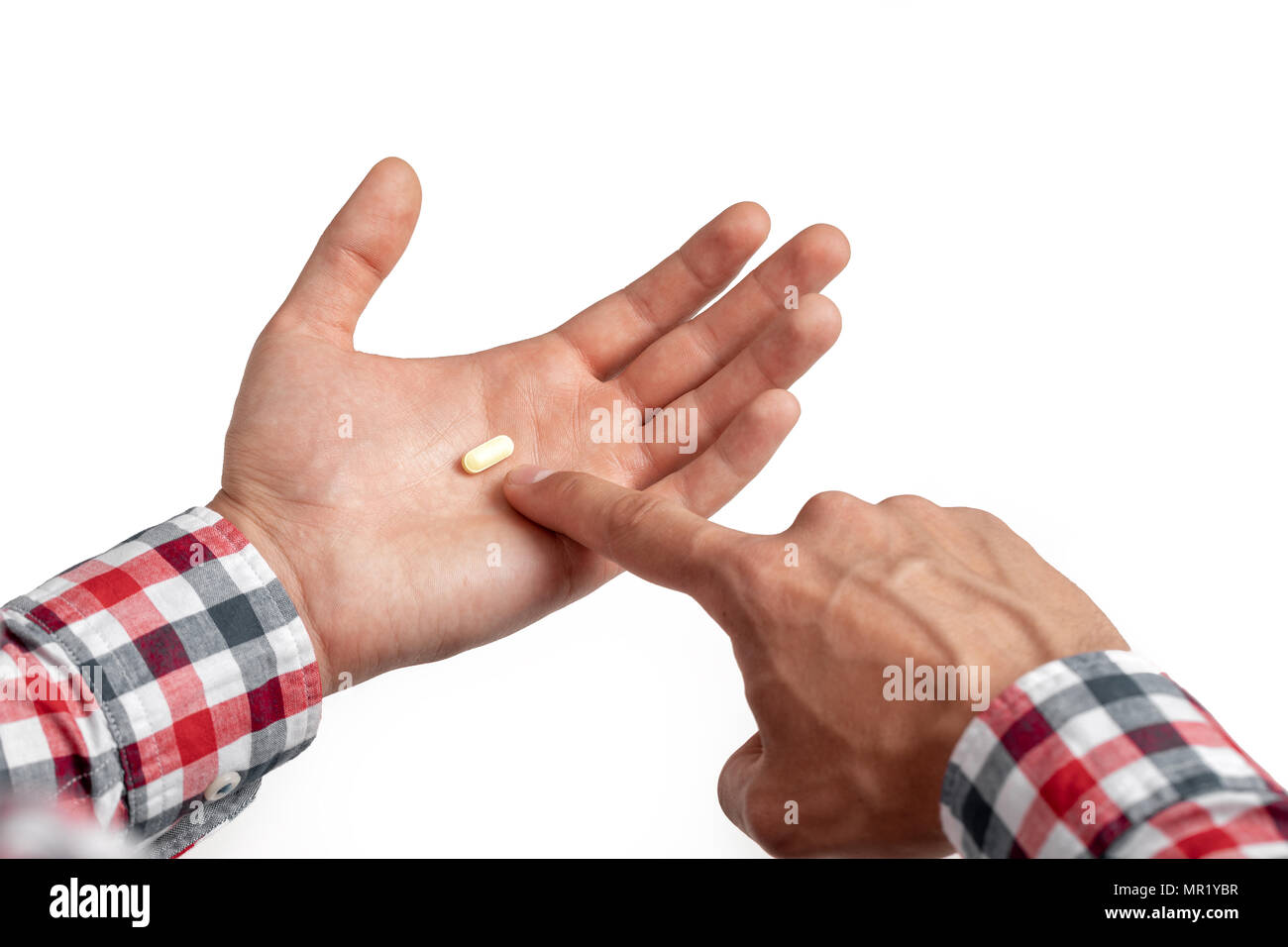 pill in man's hand on white background Stock Photo - Alamy