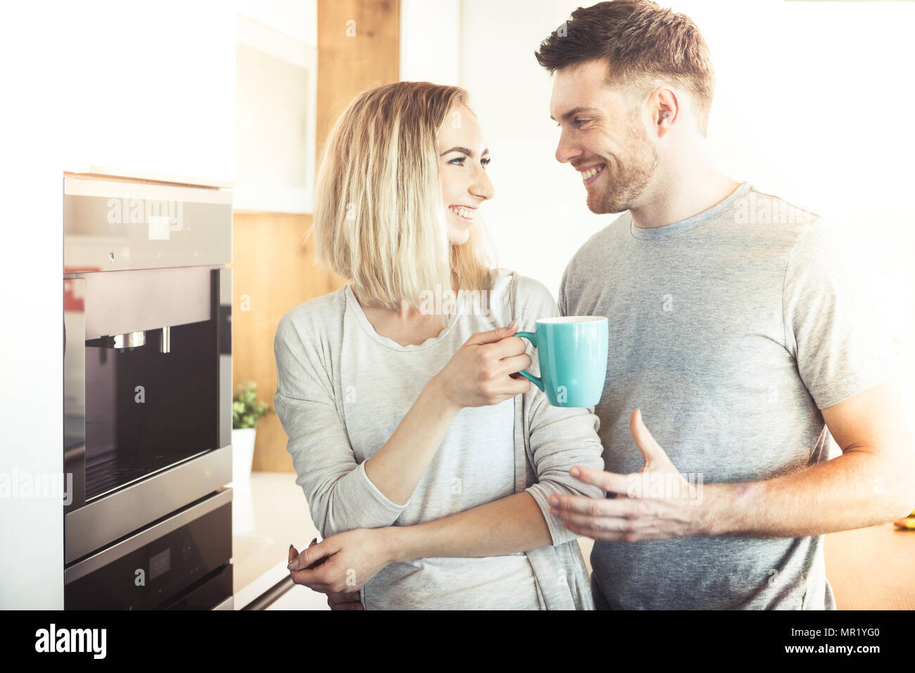 couple making coffee Stock Photo - Alamy