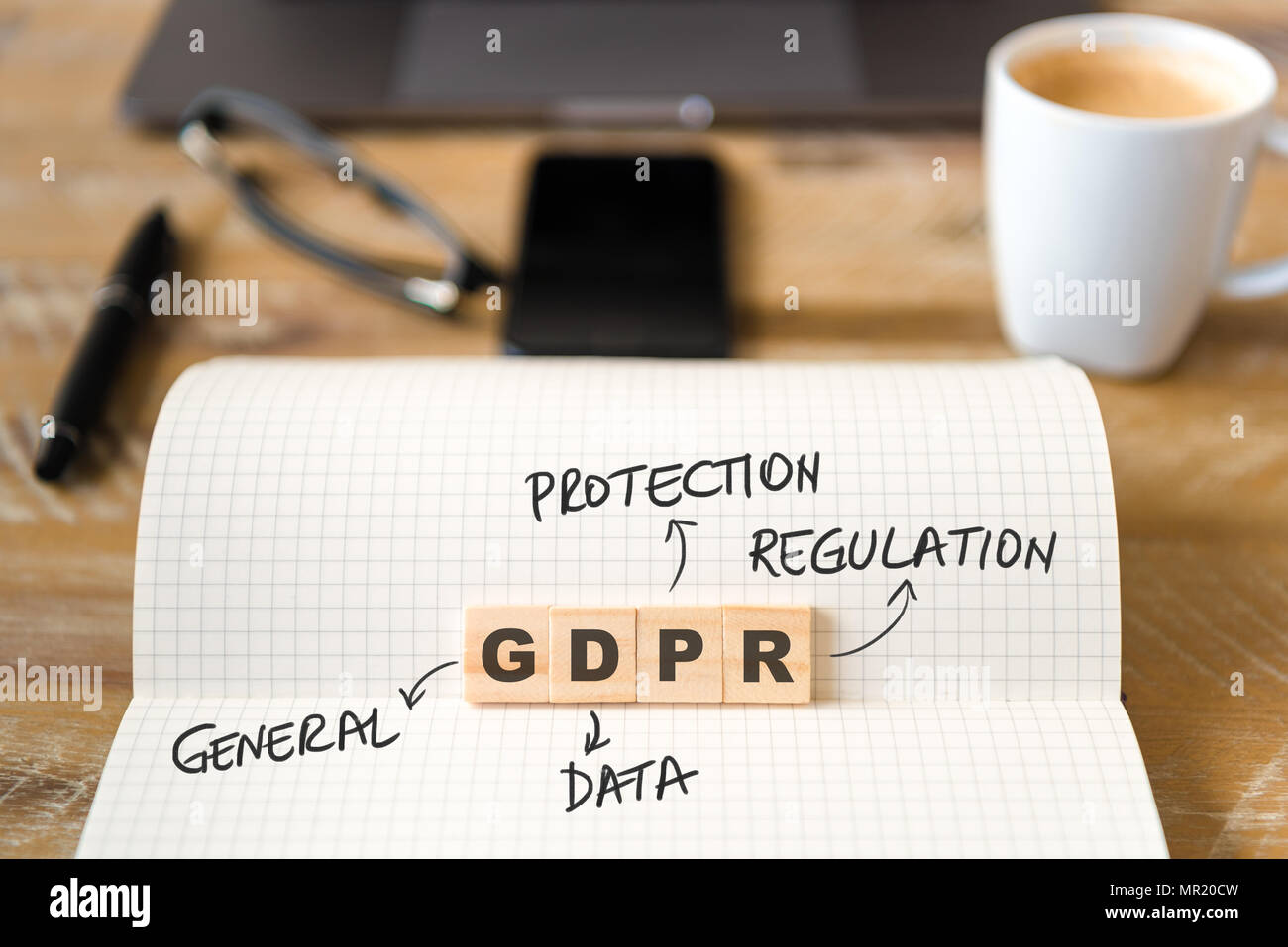 Closeup on notebook over wood table background, focus on wooden blocks ...