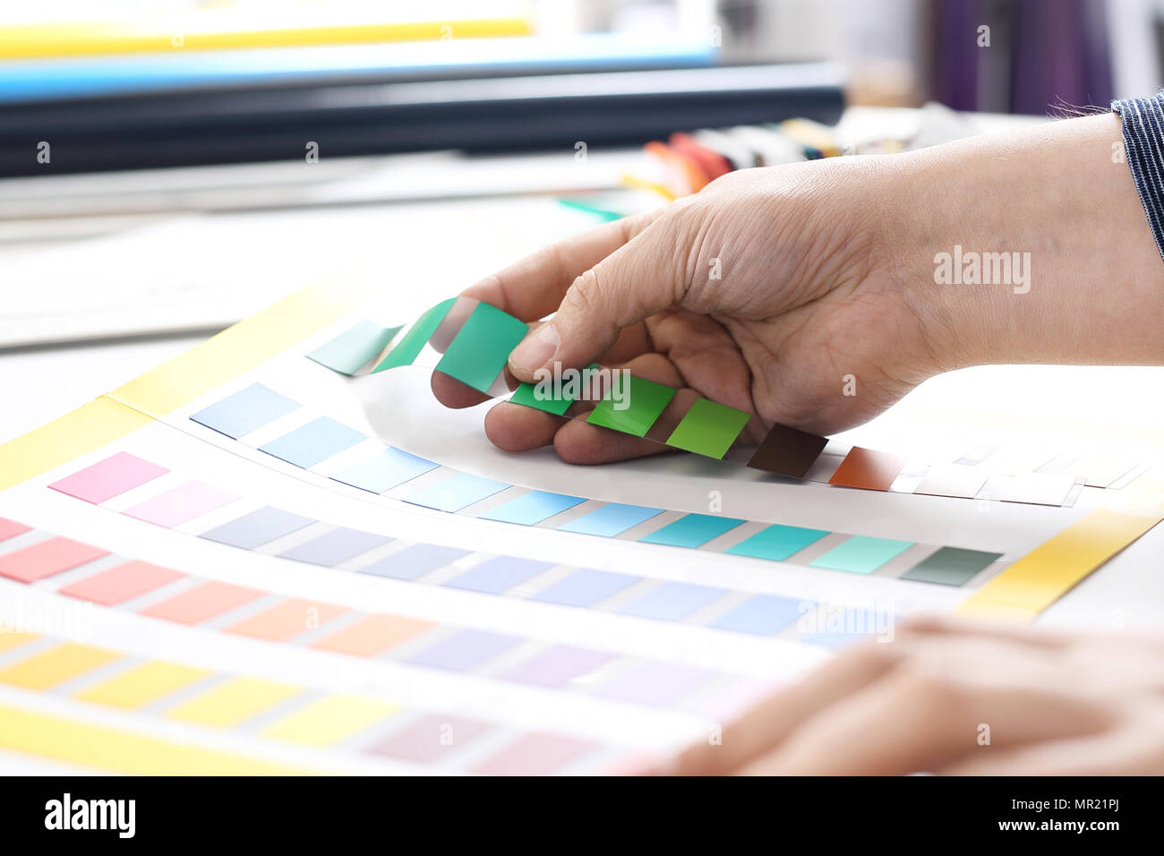 Color picker. The man compares the color Stock Photo - Alamy