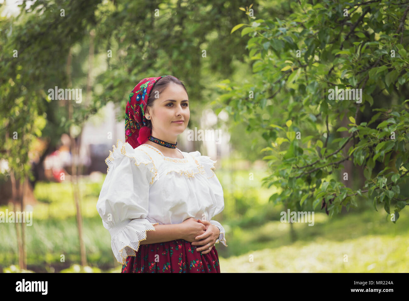 Portrait of a beautiful young woman wearing traditional Romanian ...