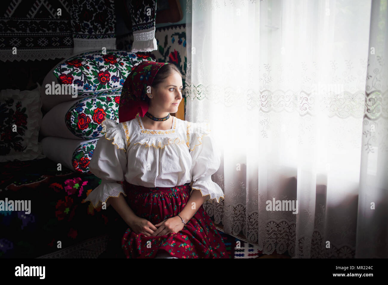 Portrait of a beautiful young woman wearing traditional Romanian ...
