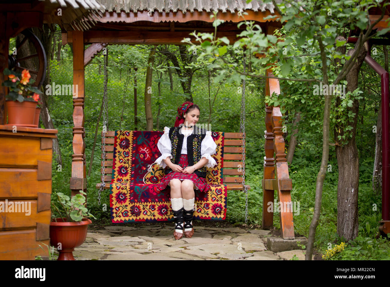 Portrait of a beautiful young woman wearing traditional Romanian ...