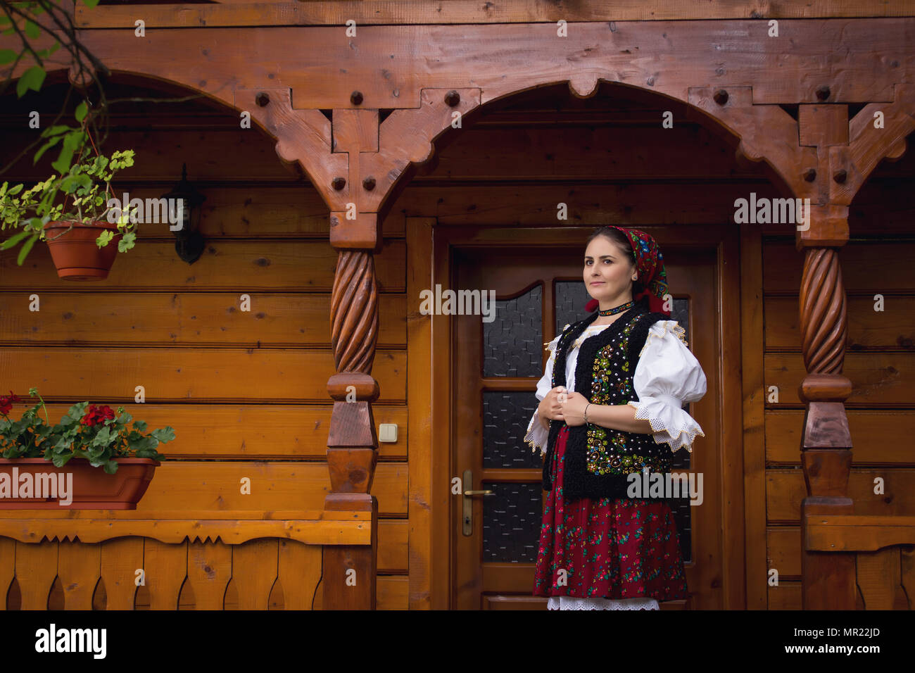 Portrait of a beautiful young woman wearing traditional Romanian ...