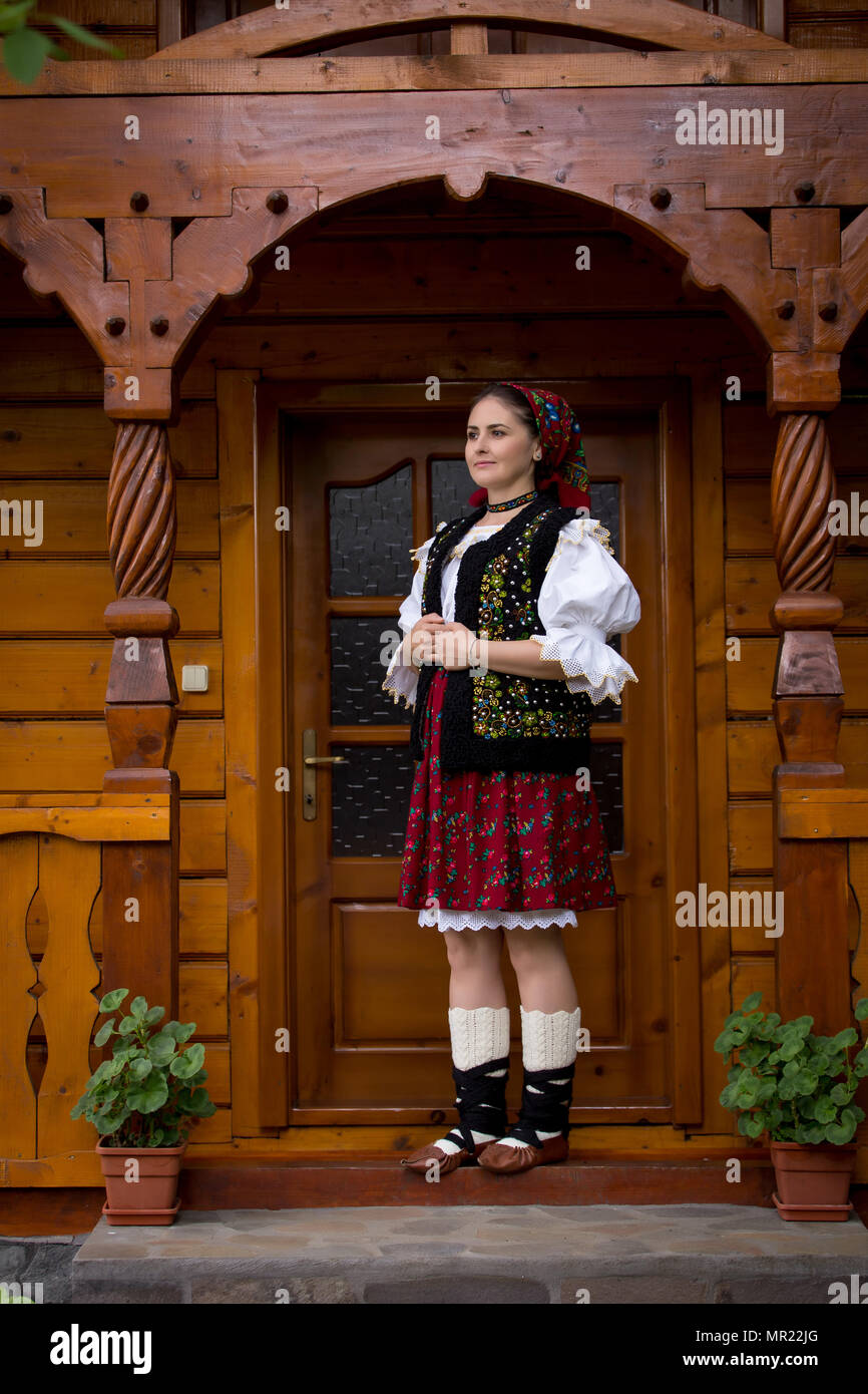 Portrait of a beautiful young woman wearing traditional Romanian ...