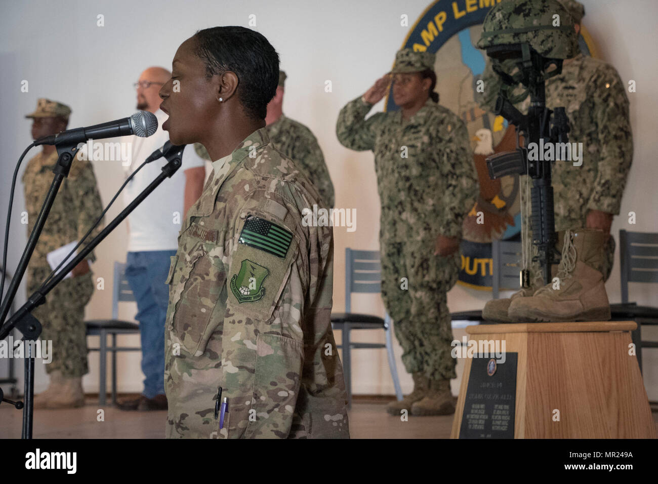 The national anthem is performed by Tech. Sgt. Laura Spurling as Naval ...