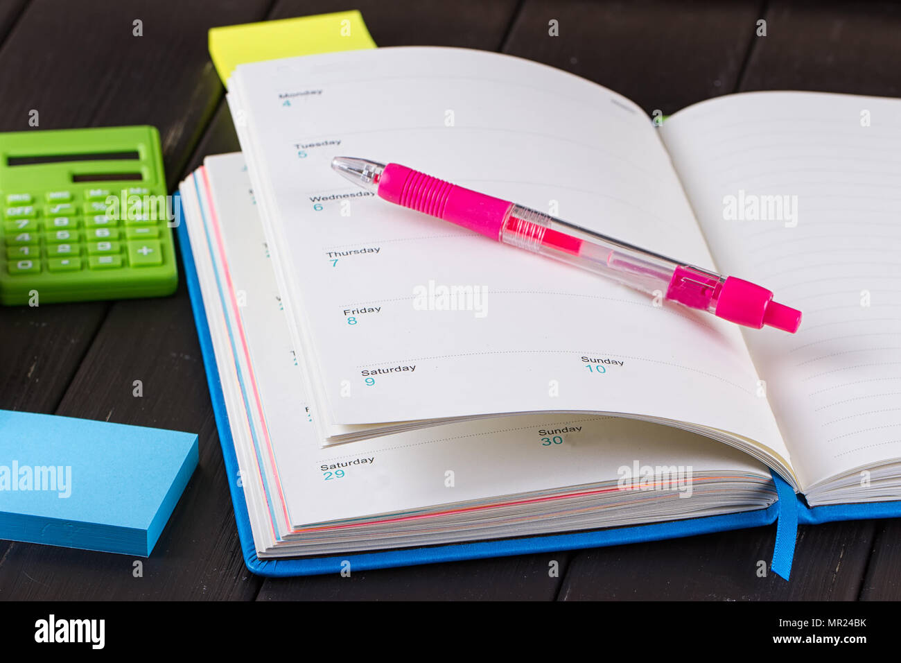 Open diary, pen on a black wooden background Stock Photo - Alamy