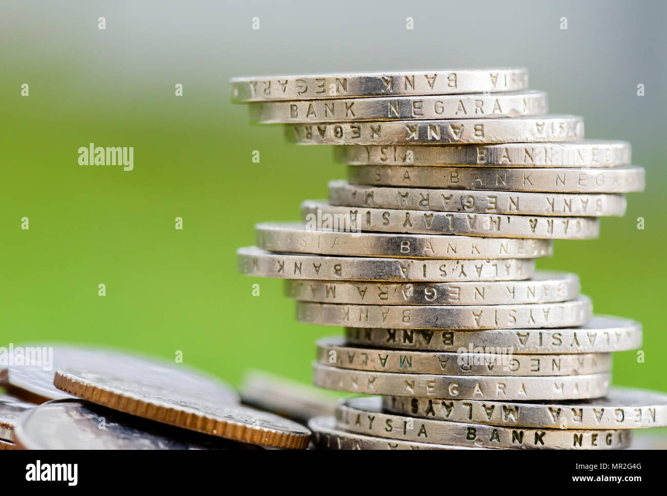 Stack of coins with green glass background for money savings concept ...