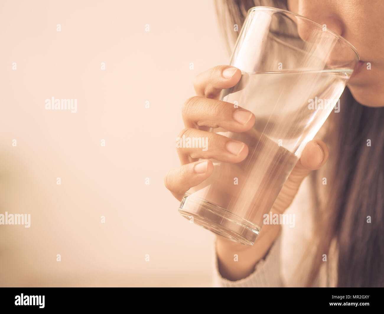Retro young woman drinking water from glass.Health care concept Stock ...
