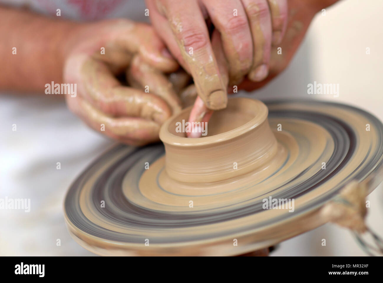 Hands working on pottery wheel Stock Photo - Alamy