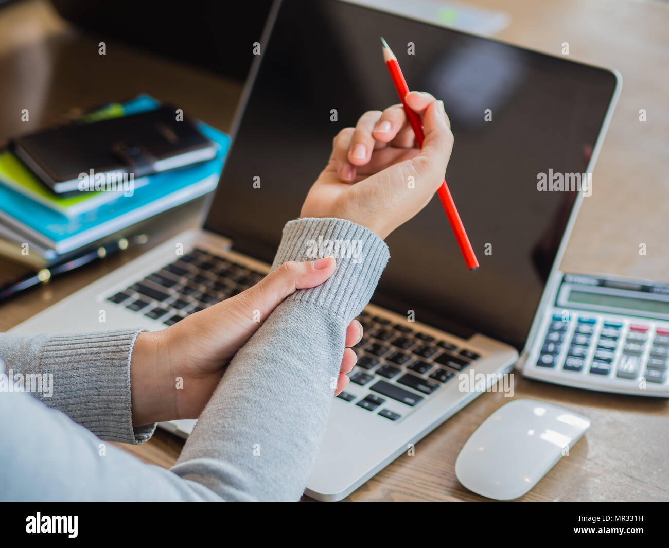 Closeup woman holding her wrist pain from using computer long time ...