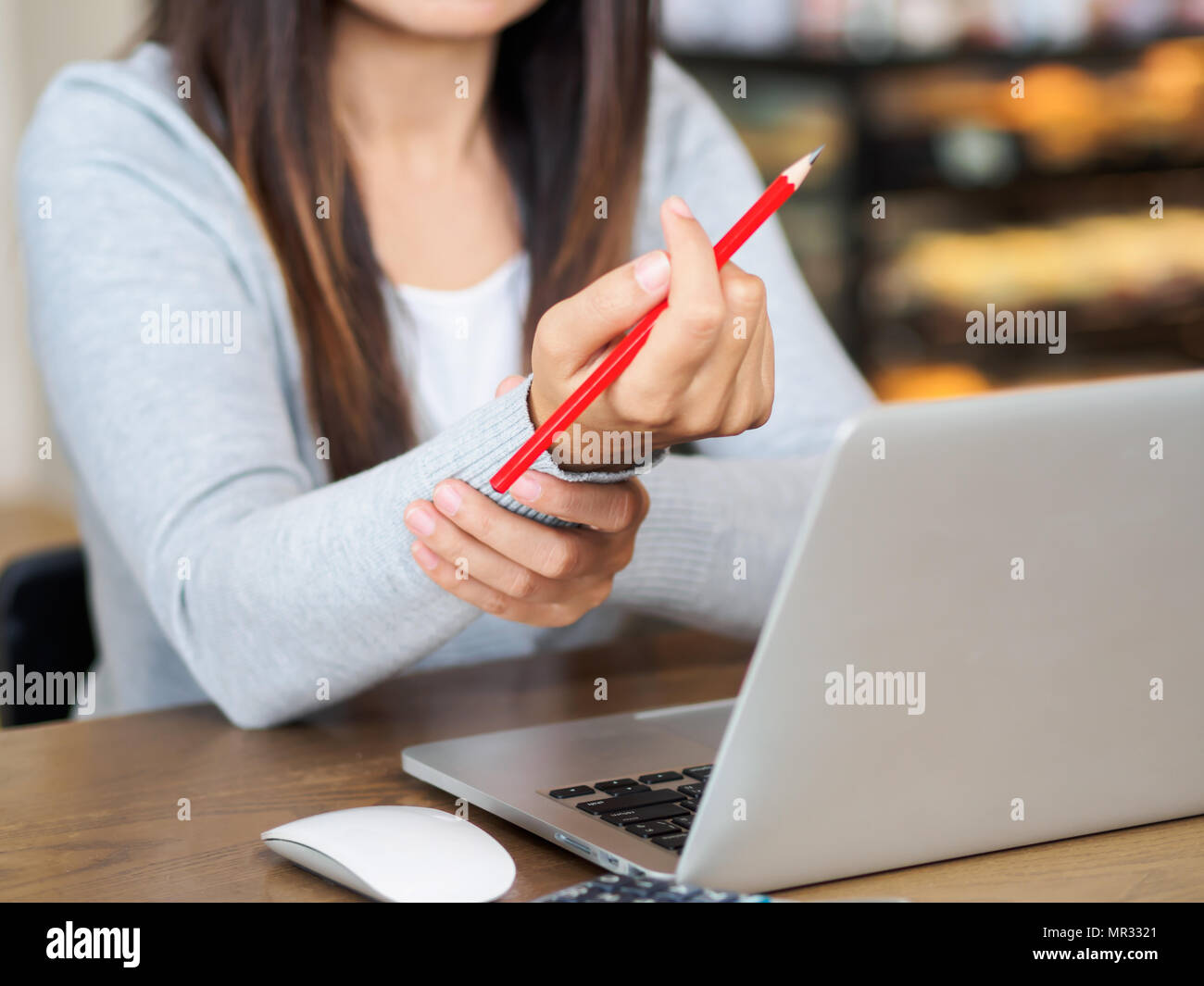 Closeup woman holding her wrist pain from using computer long time ...